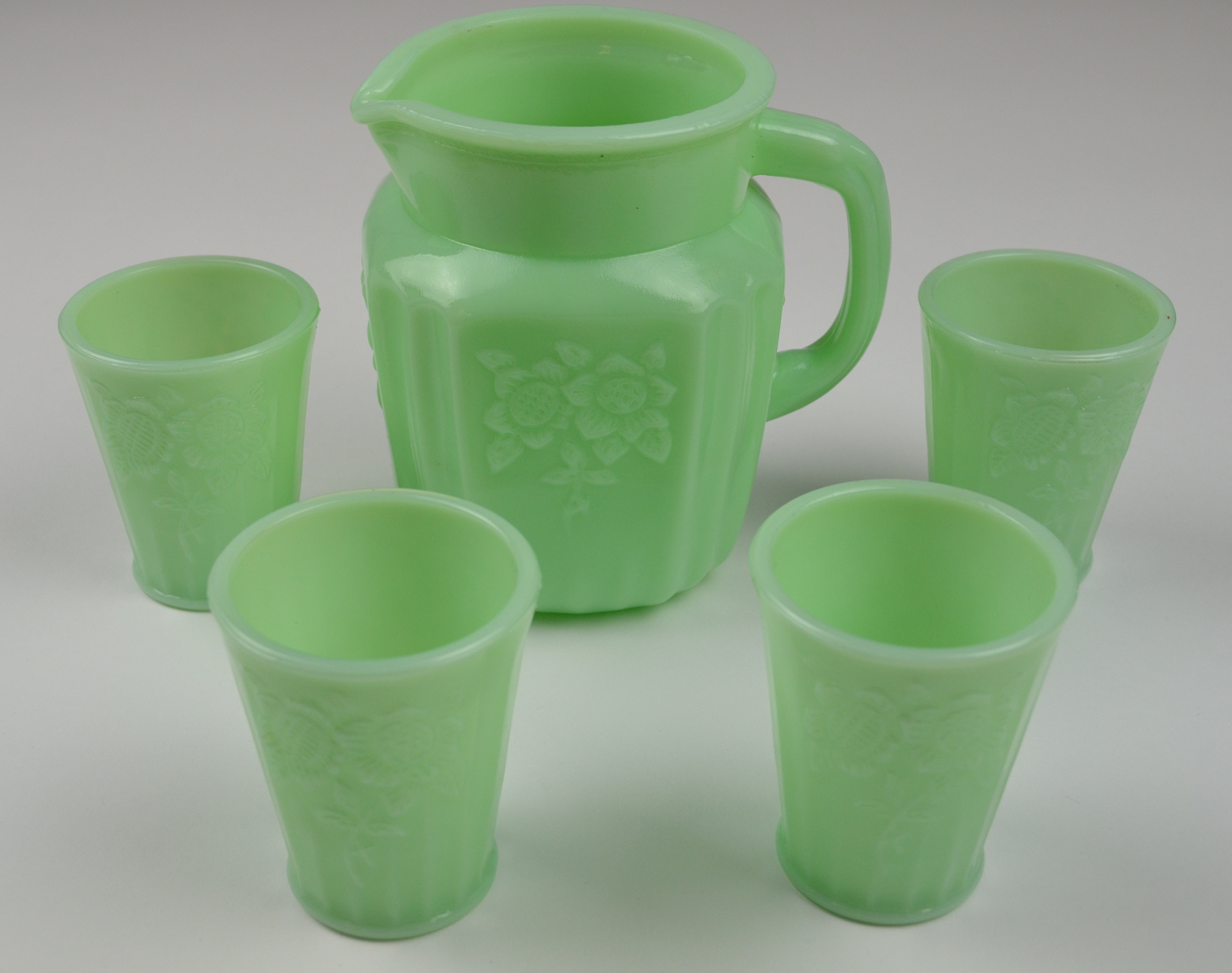 Jadeite Floral Pattern 6" Water Pitcher And Four 3.25" Glasses